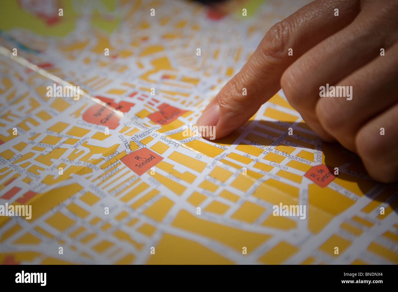 Finger pointing on map Stock Photo - Alamy