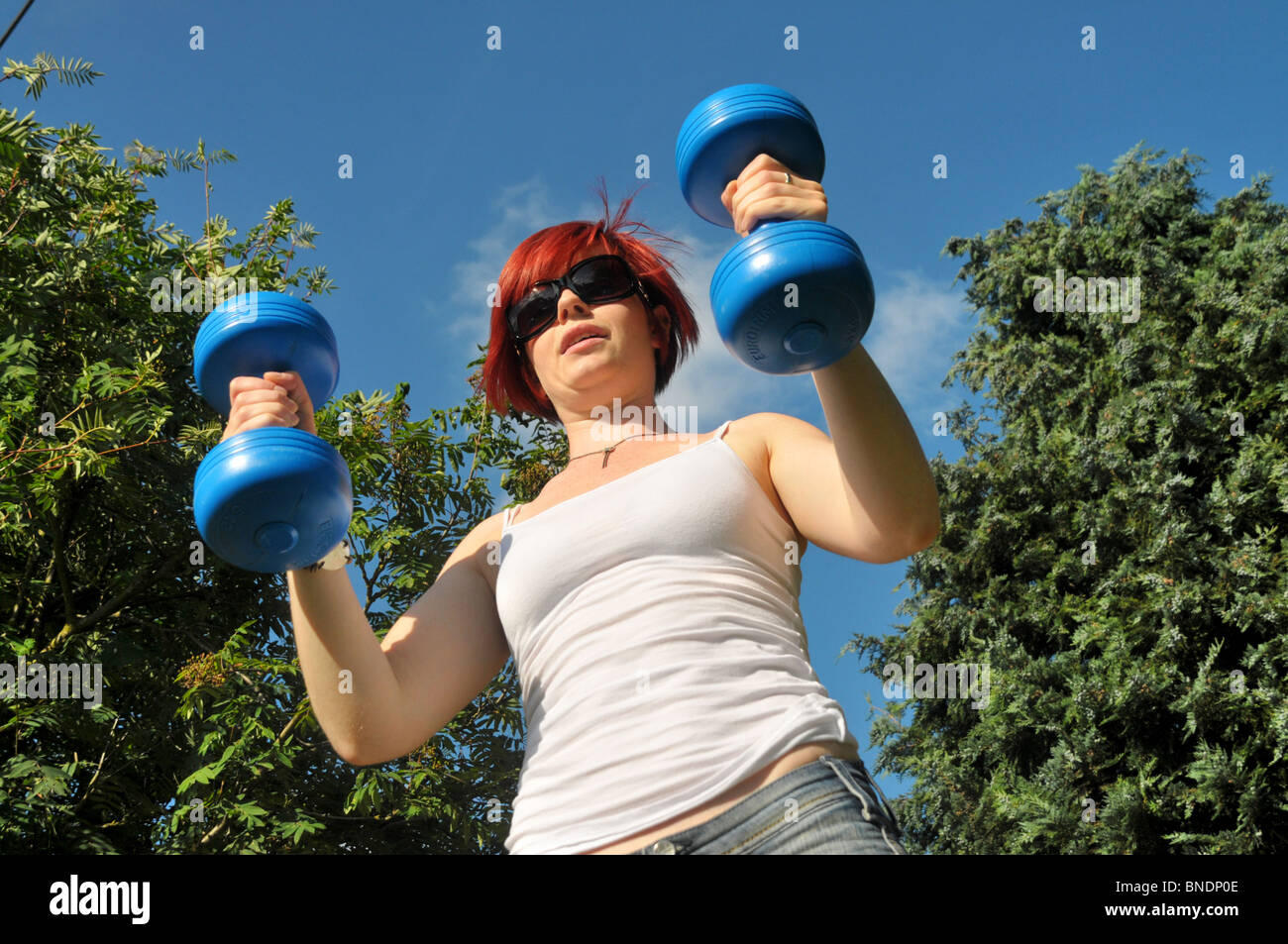 a young red headed girl exercises using hand weights Stock Photo - Alamy