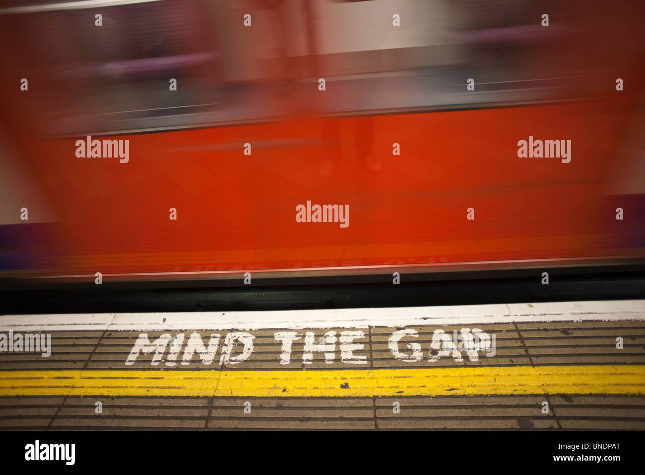 Mind The Gap warning sign on the floor of a railway platform, London ...