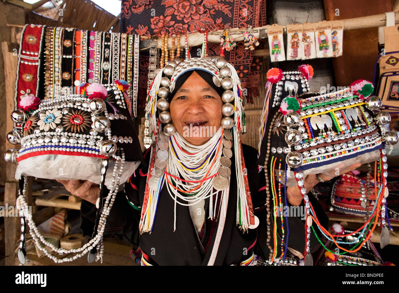 Akha tribal woman in traditional clothing at a market stall, Chiang Mai ...