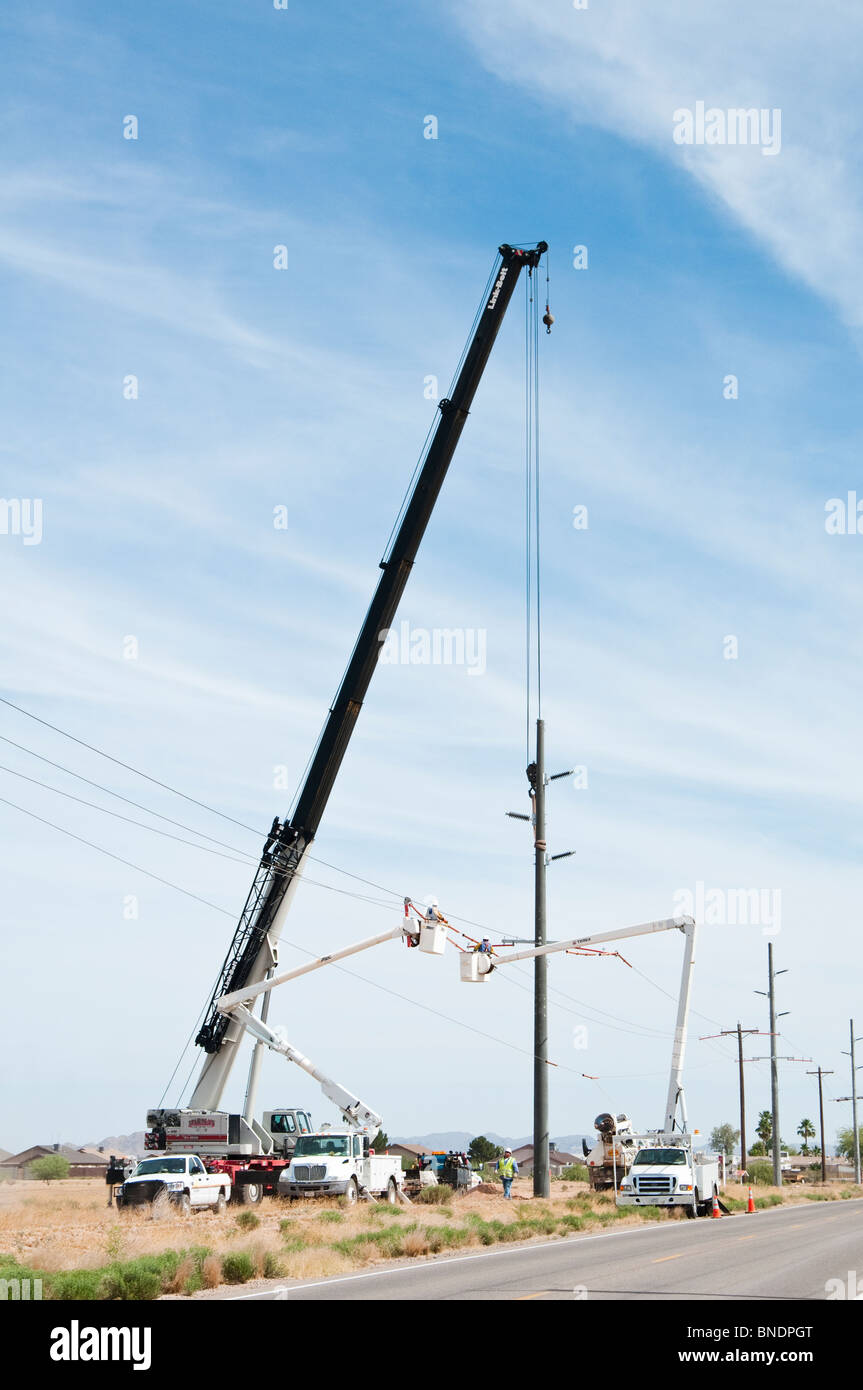Construction workers in cherry picker baskets work on a new power ...
