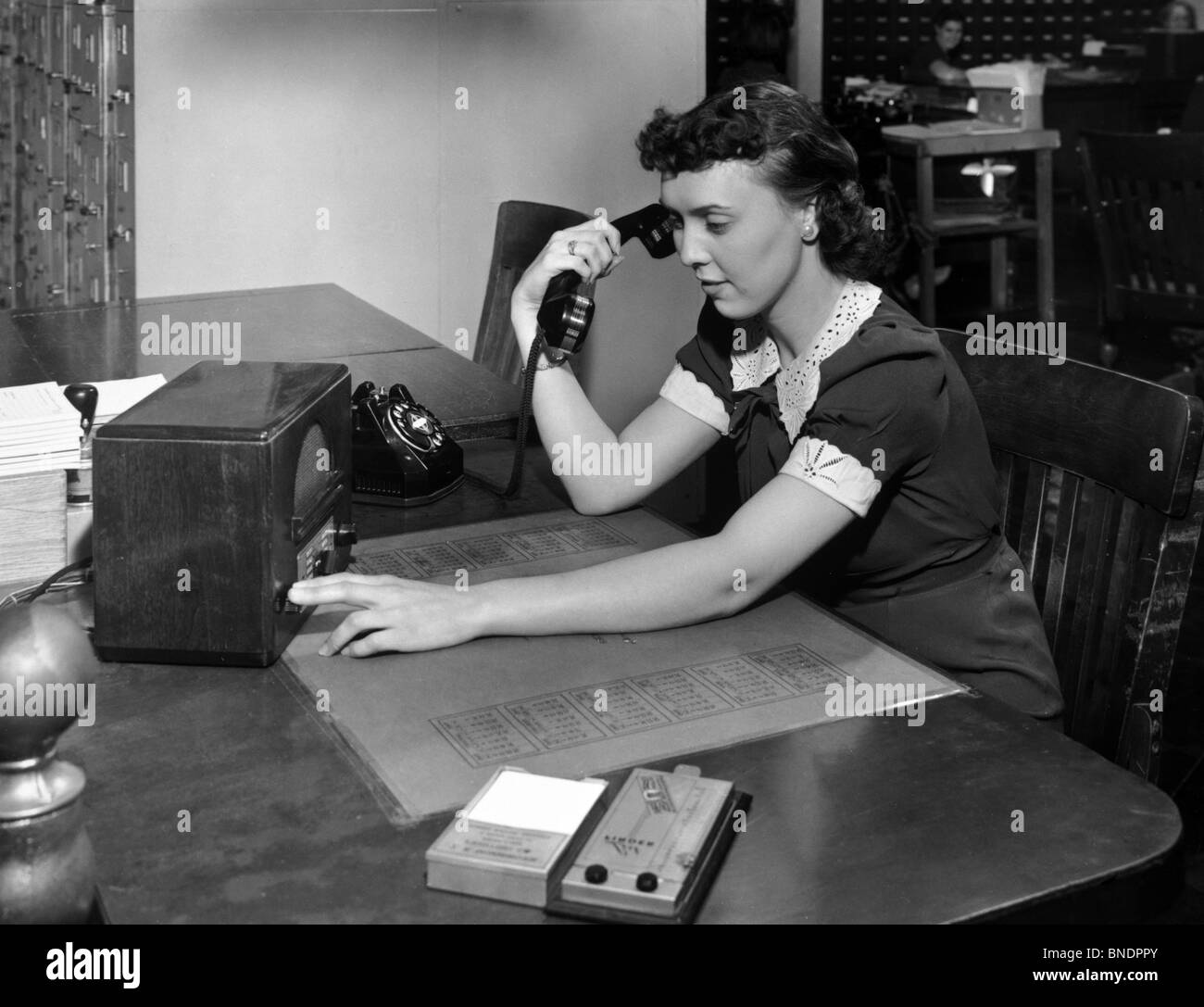 Side profile of a young woman using a telephone, 1941 Stock Photo - Alamy