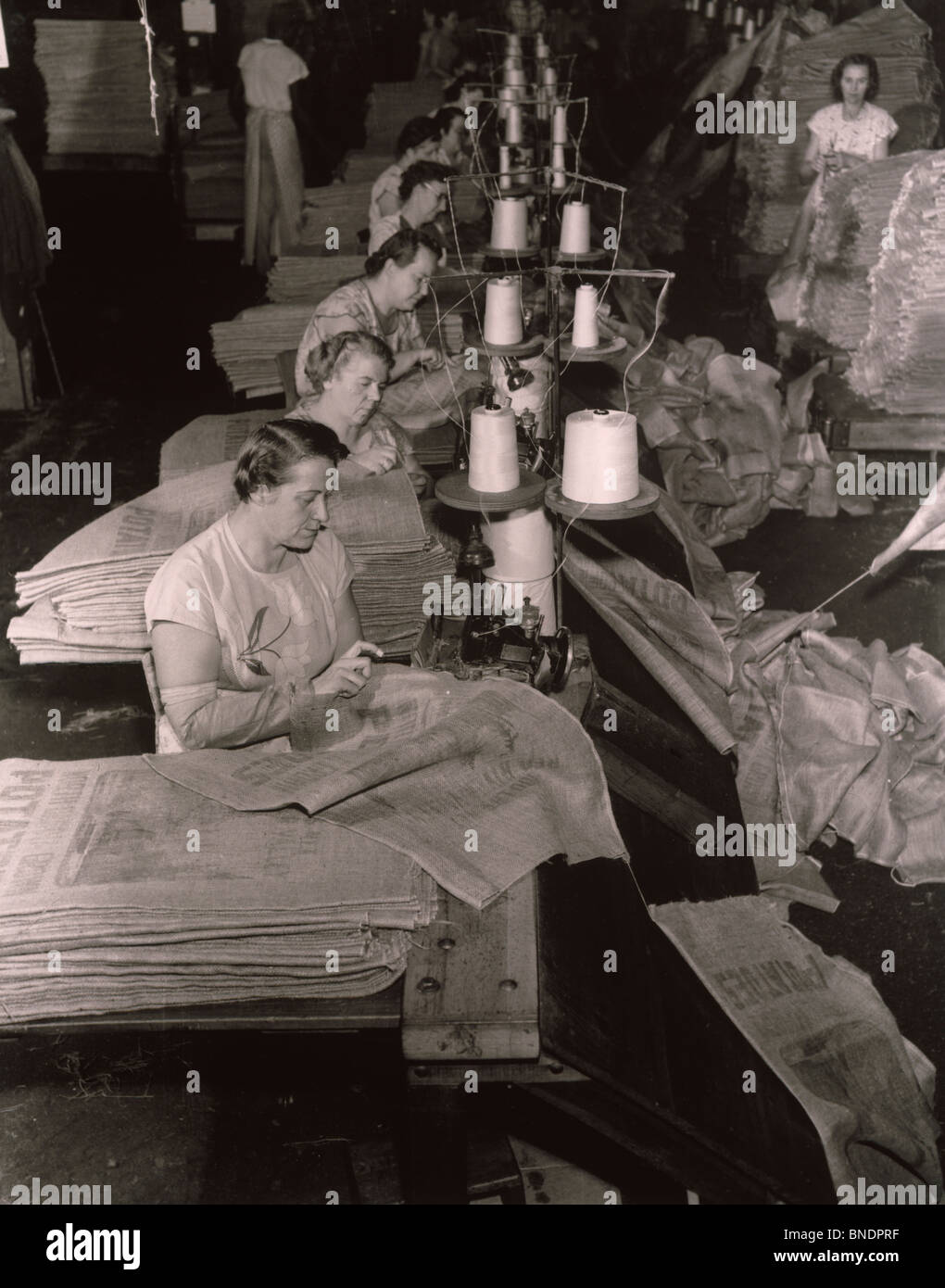 Group of women sewing potato sacks hi-res stock photography and images ...