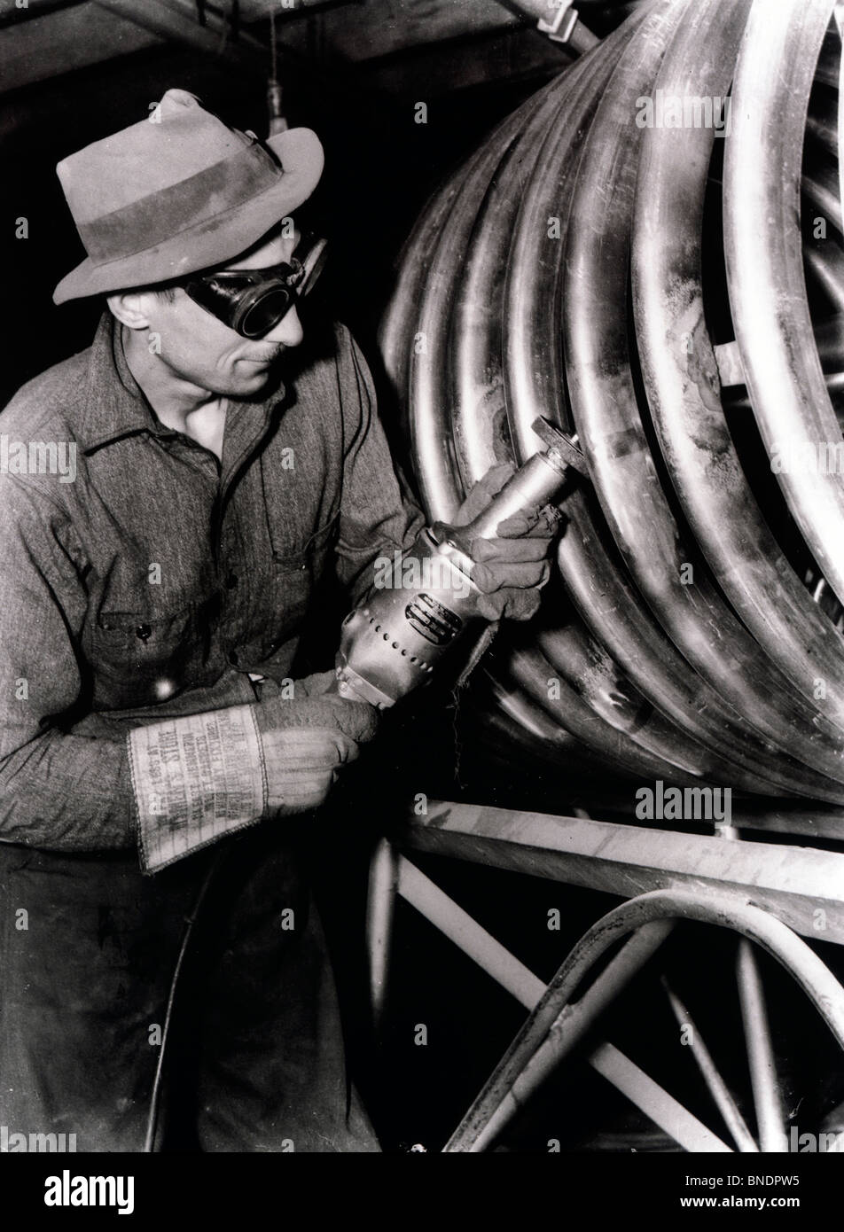 Manual worker using a metal sander in a factory Stock Photo - Alamy