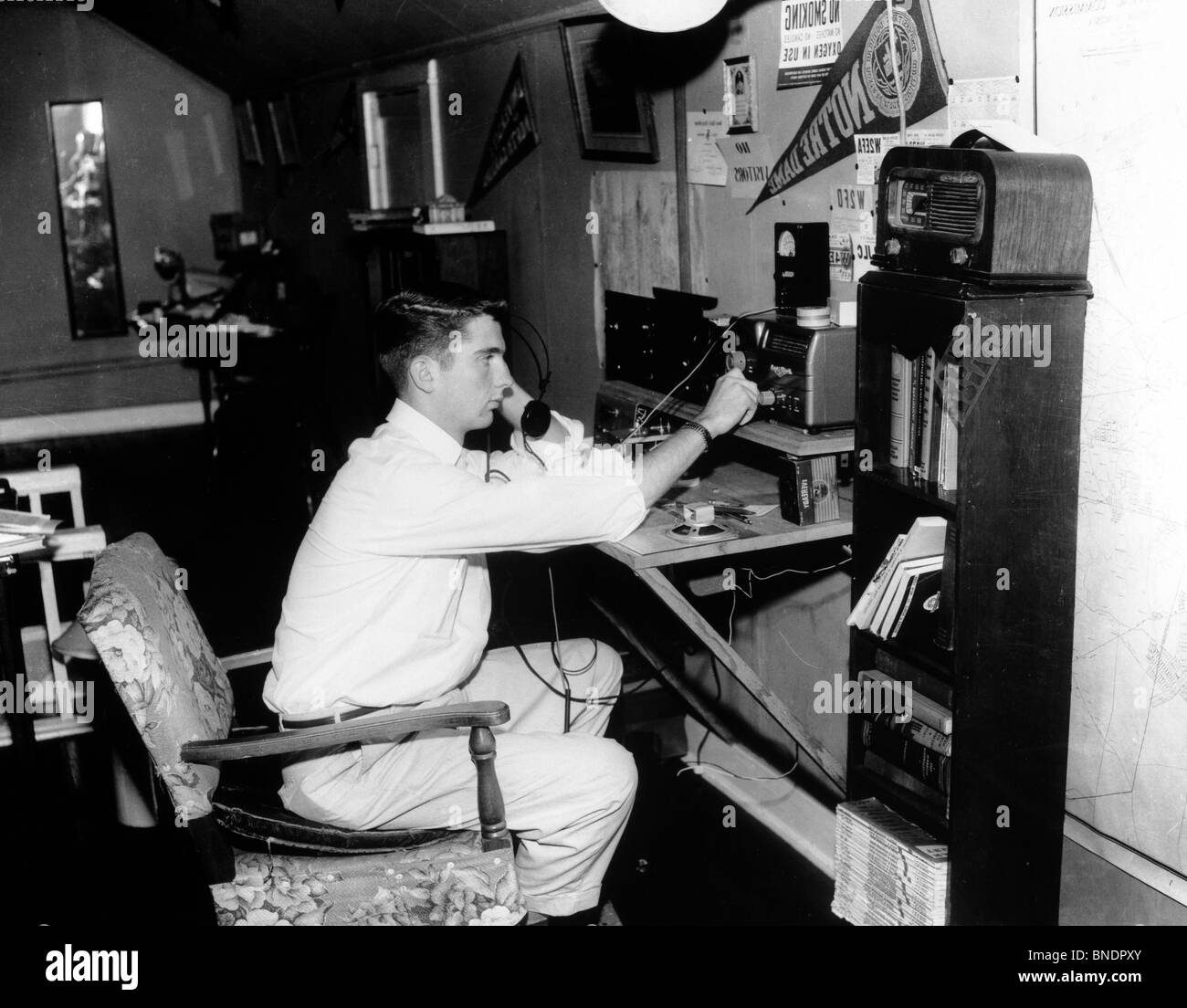 Side profile of a college student tuning short wave radio, 1954 Stock ...