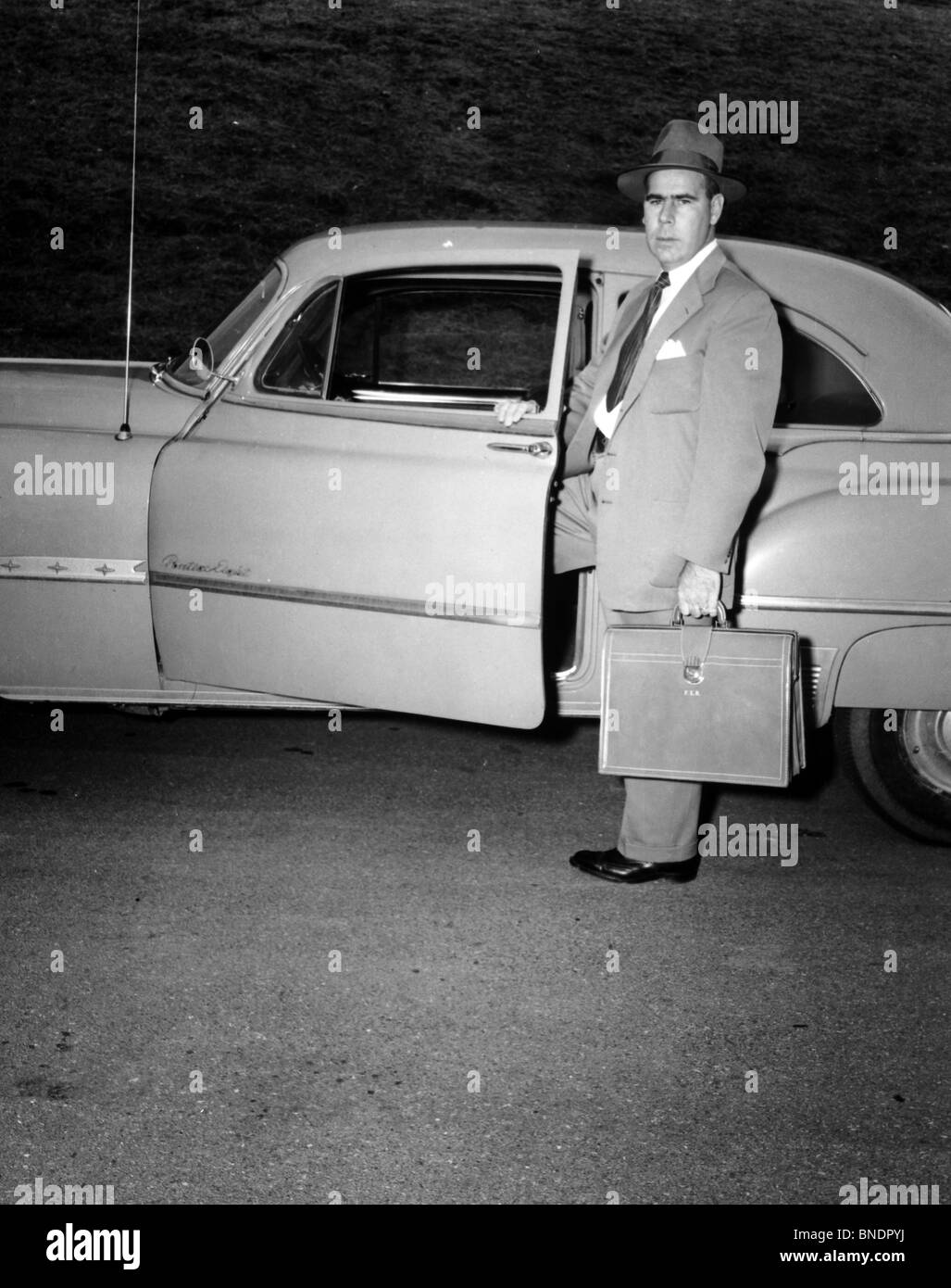 Side profile of a businessman standing near a car Stock Photo - Alamy