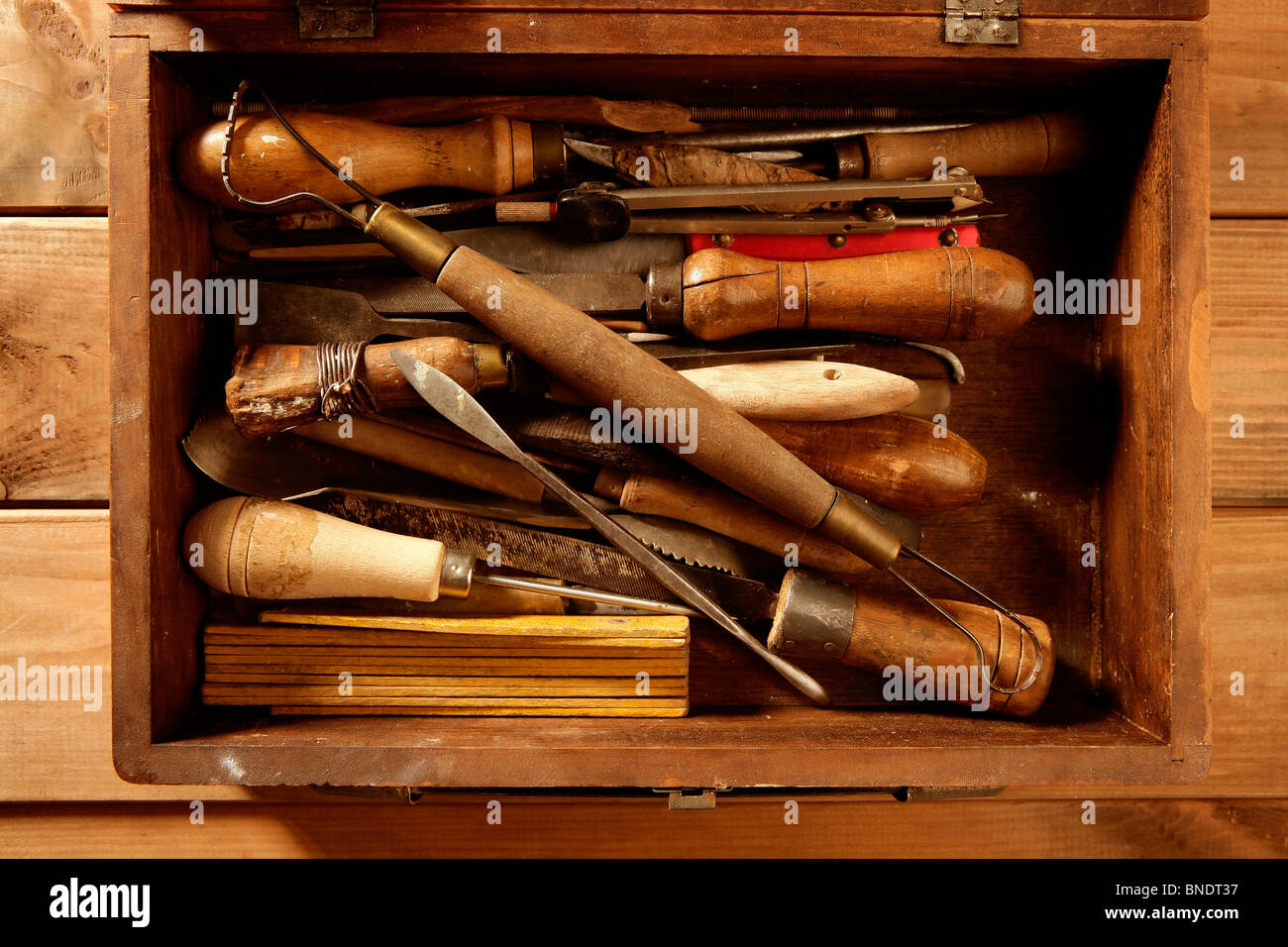 artist hand tools for handcraft works on golden wood background Stock ...