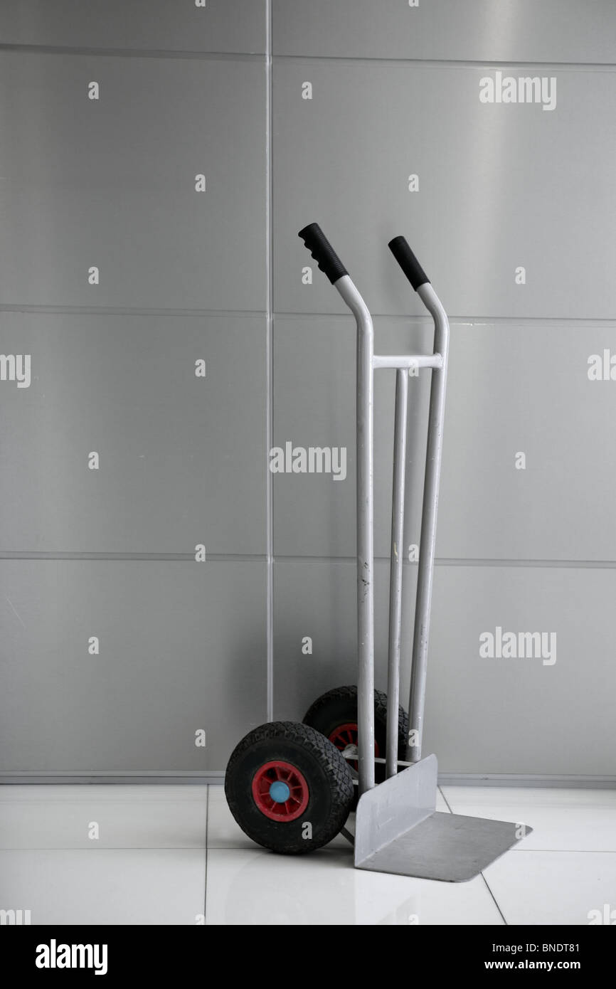 boxes barrow vertical trolley silver gray background Stock Photo - Alamy
