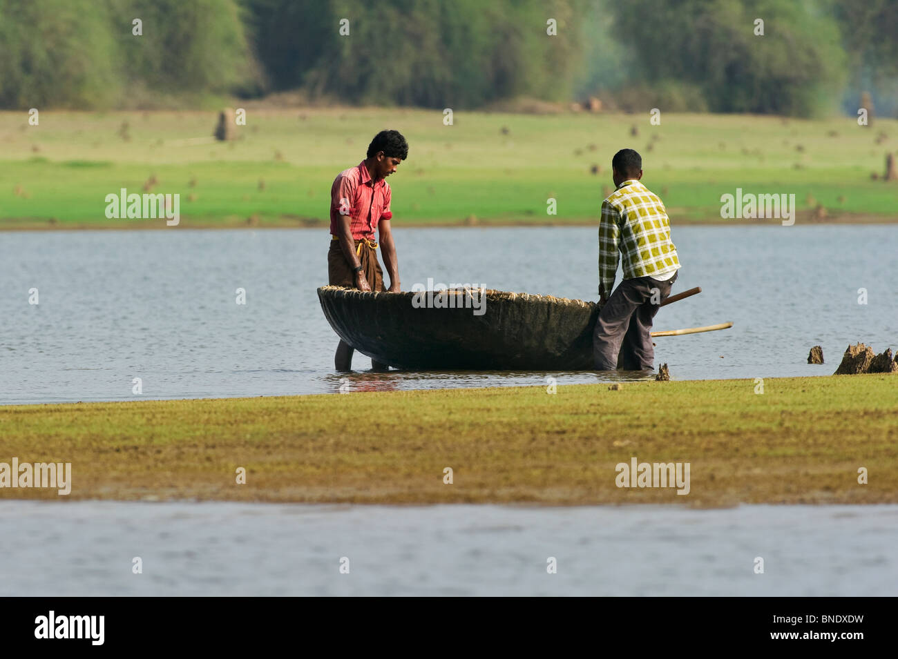 India Karnataka Nagarhole National Park fishers beaching a boat on the ...