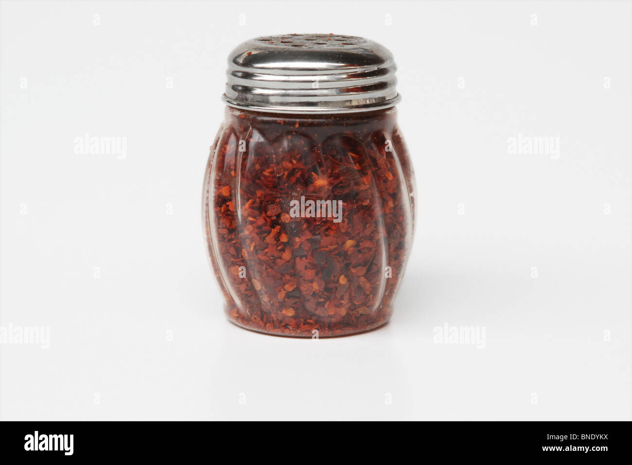 Red Pepper shaker on white background Stock Photo - Alamy