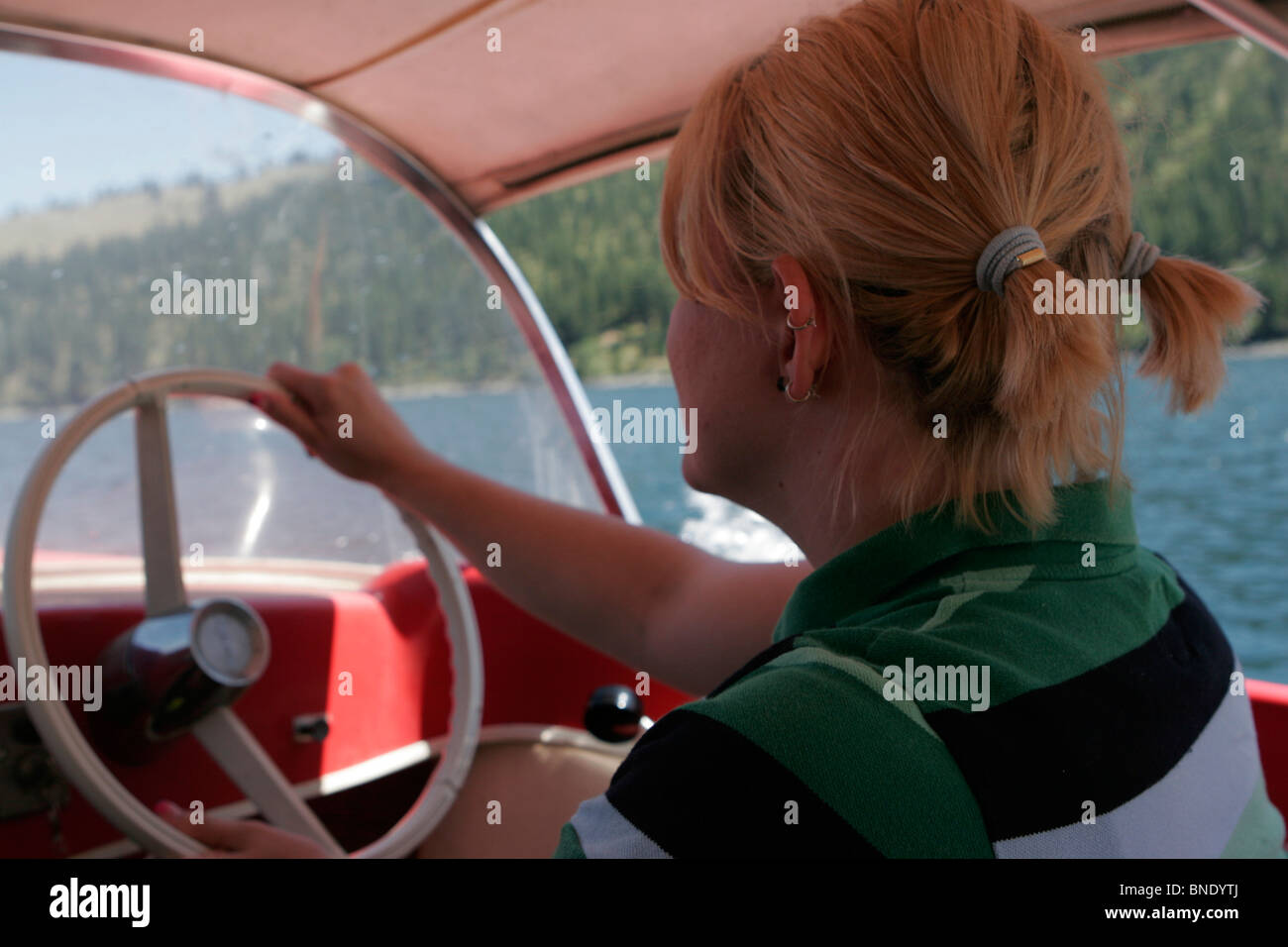 Young woman driving a motorboat Stock Photo - Alamy
