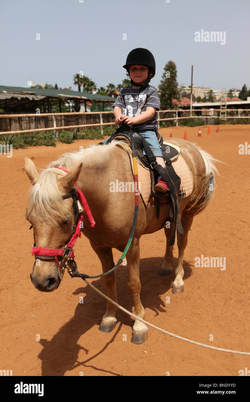 Young boy of four rides a pony Model Release Available Stock Photo - Alamy