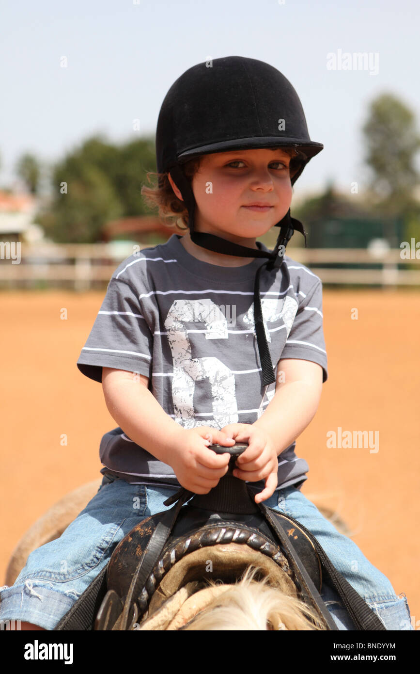 Young boy of four rides a pony Model Release Available Stock Photo - Alamy