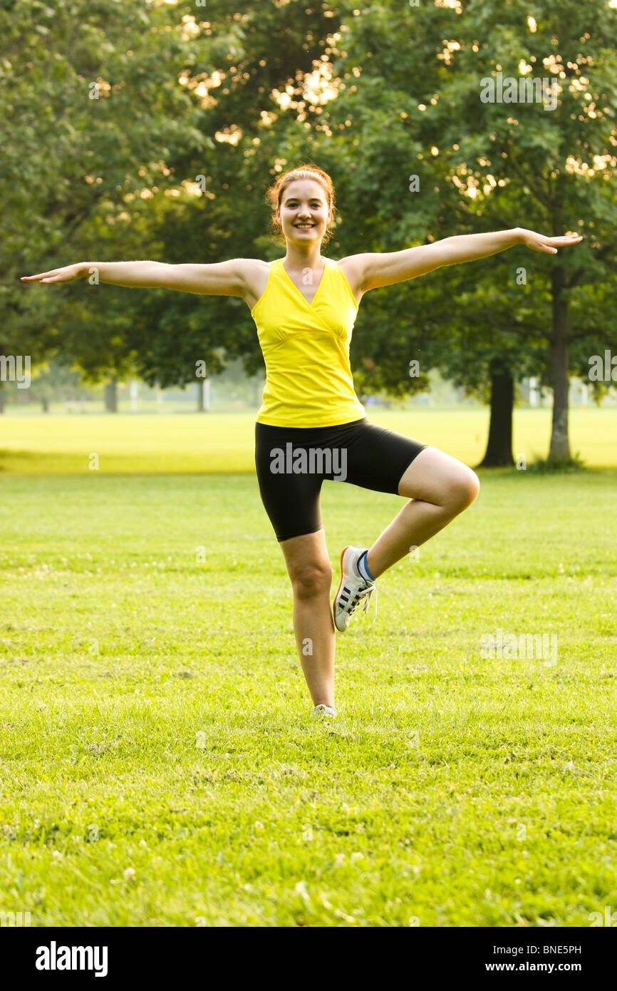 woman yoga pose outdoor park evening balance Stock Photo - Alamy