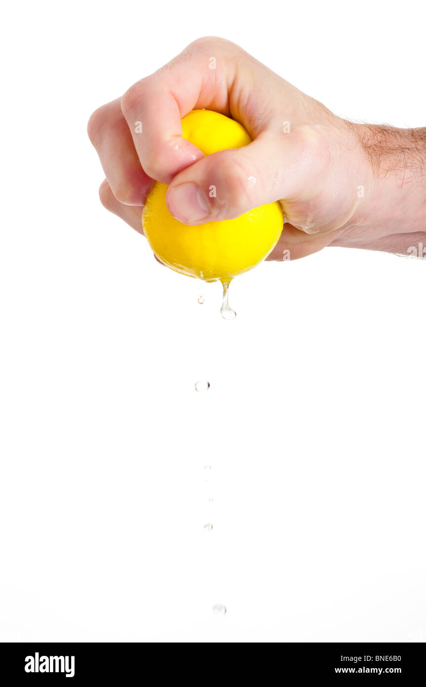 hand squeezing juicy lemon with juice dripping Stock Photo - Alamy
