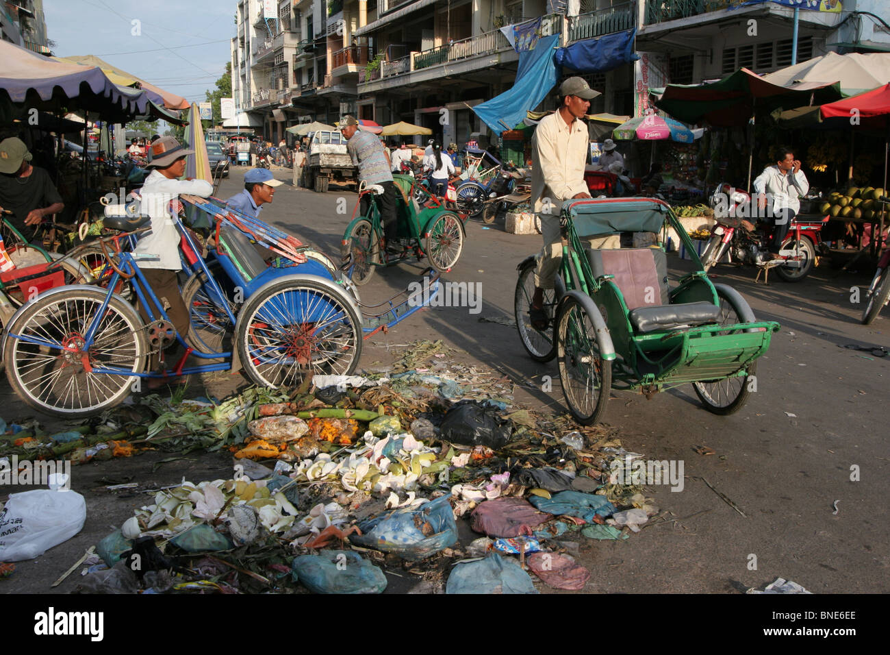 Cyclos in a market in Phnom Penh, Cambodia Stock Photo - Alamy