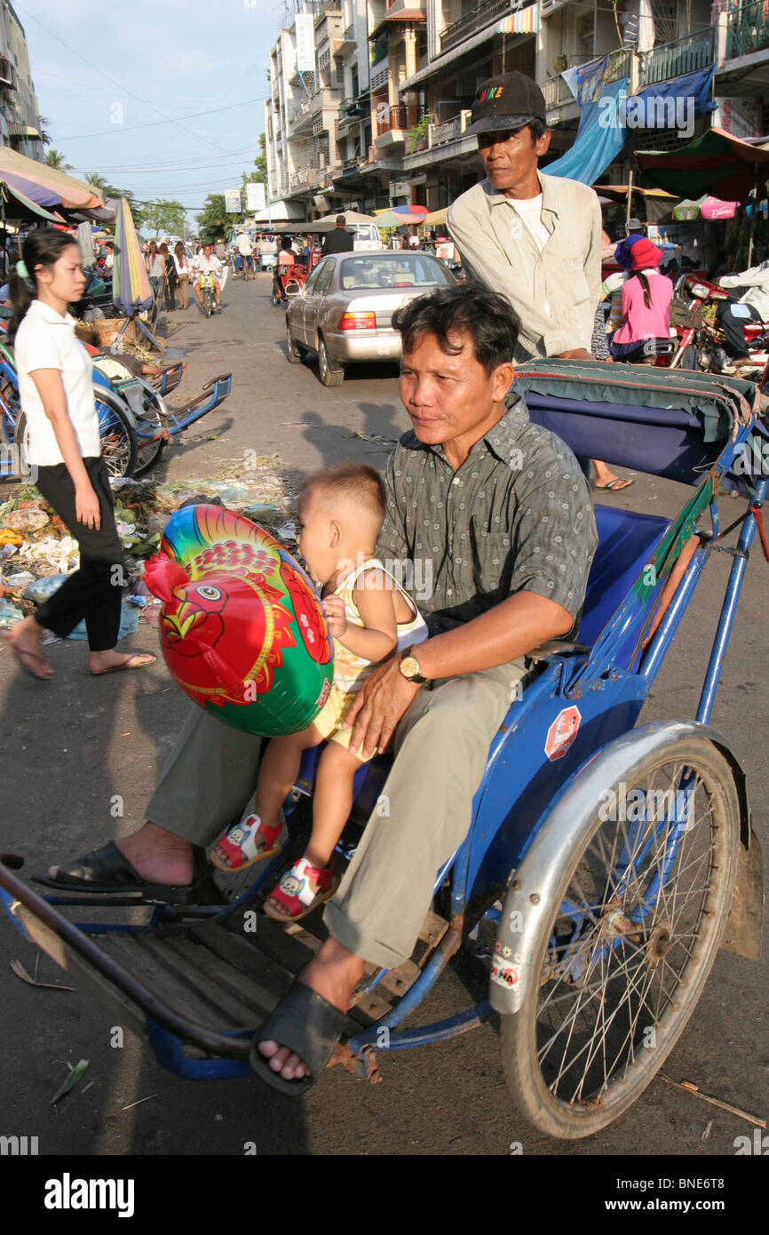 A cyclo driver with customers in Phnom Penh, Cambodia Stock Photo - Alamy