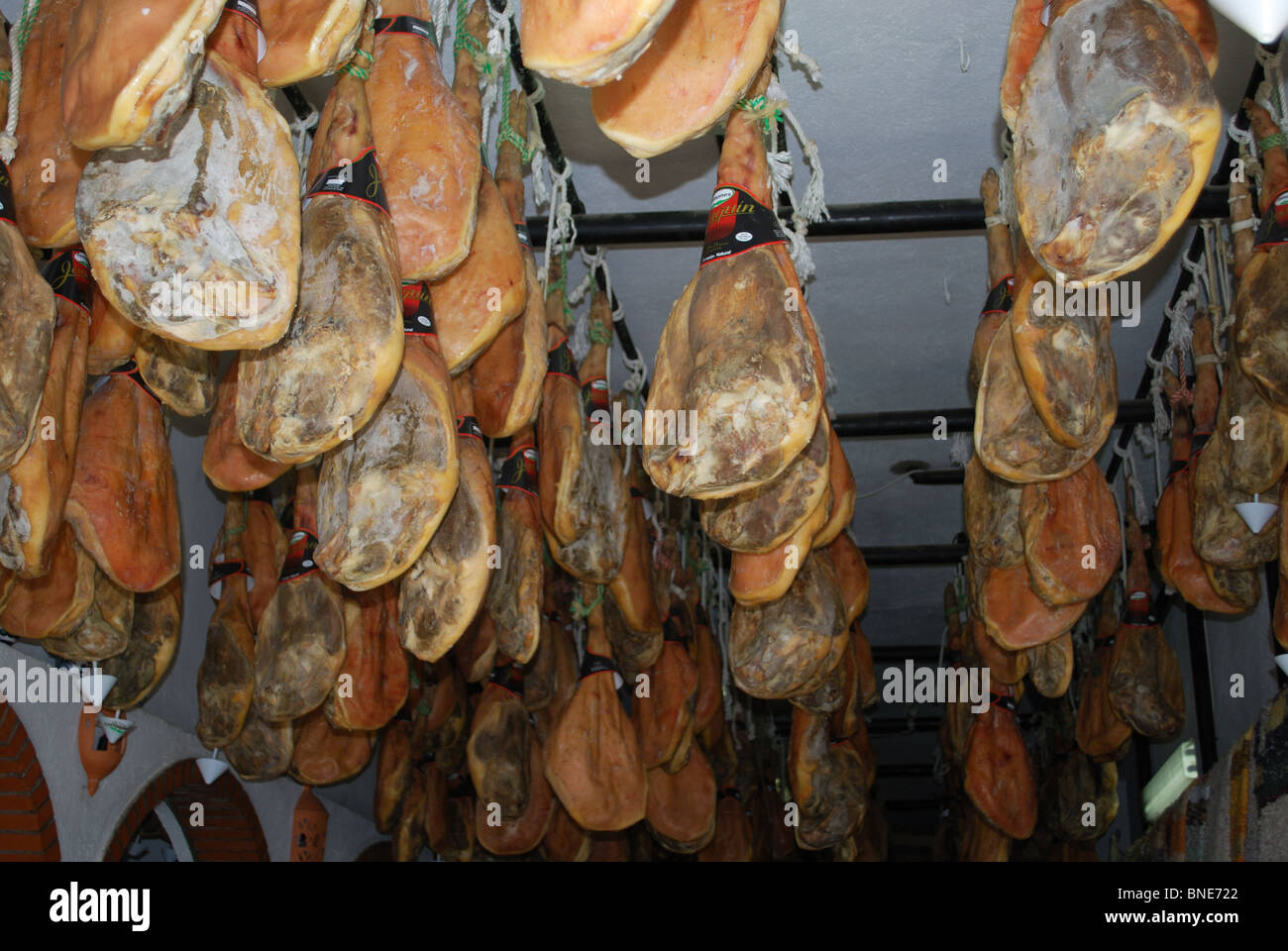 Cured legs of ham (Jamon Serrano) hanging in a shop, Trevelez, Las ...