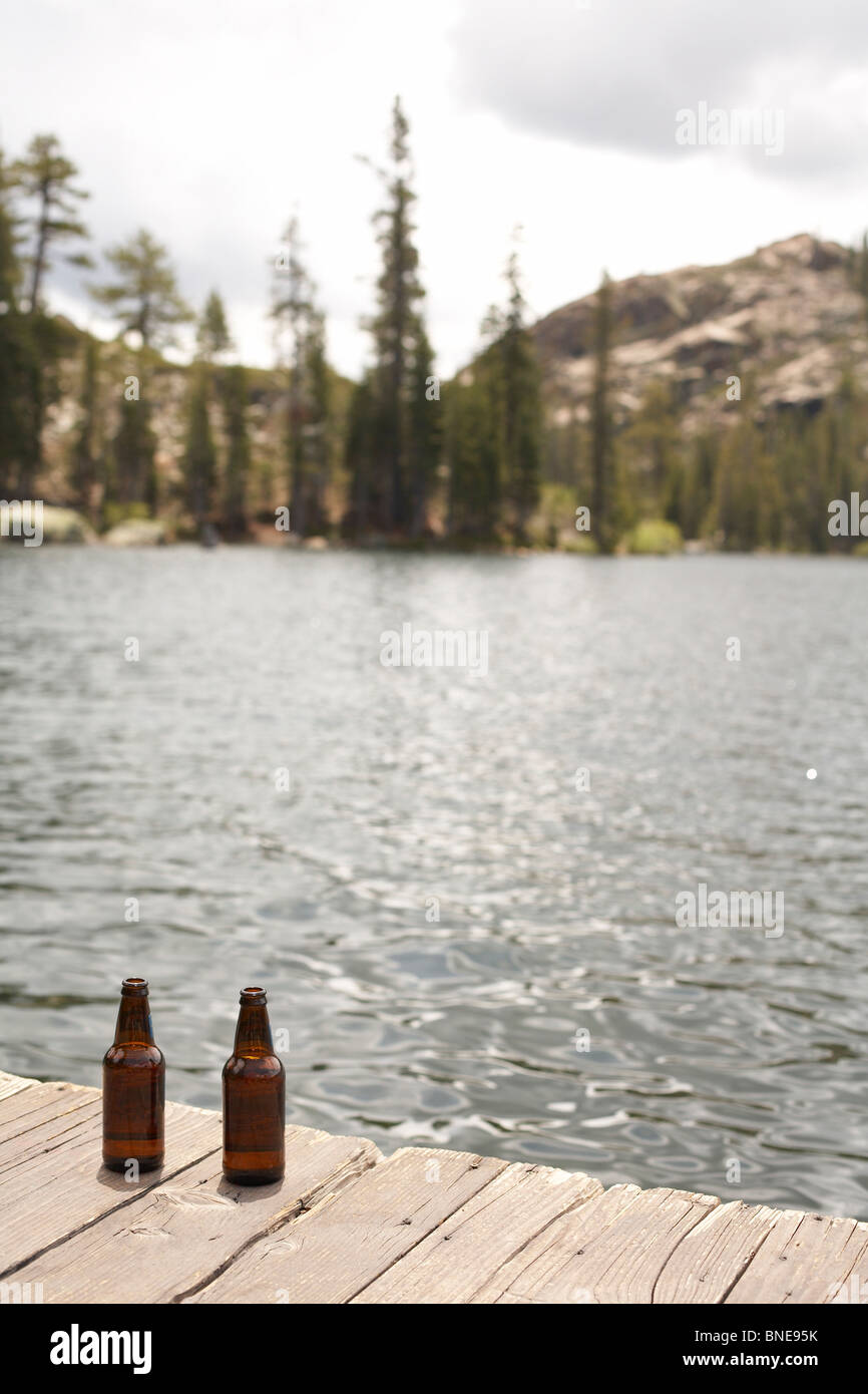 Beer bottles on a pier at the lakeside Stock Photo - Alamy