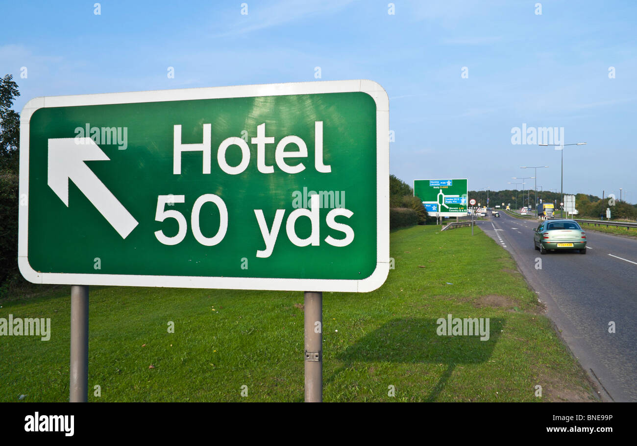 Hotel turnoff 50 yds (50m) shown on British urban road near M6 motorway ...