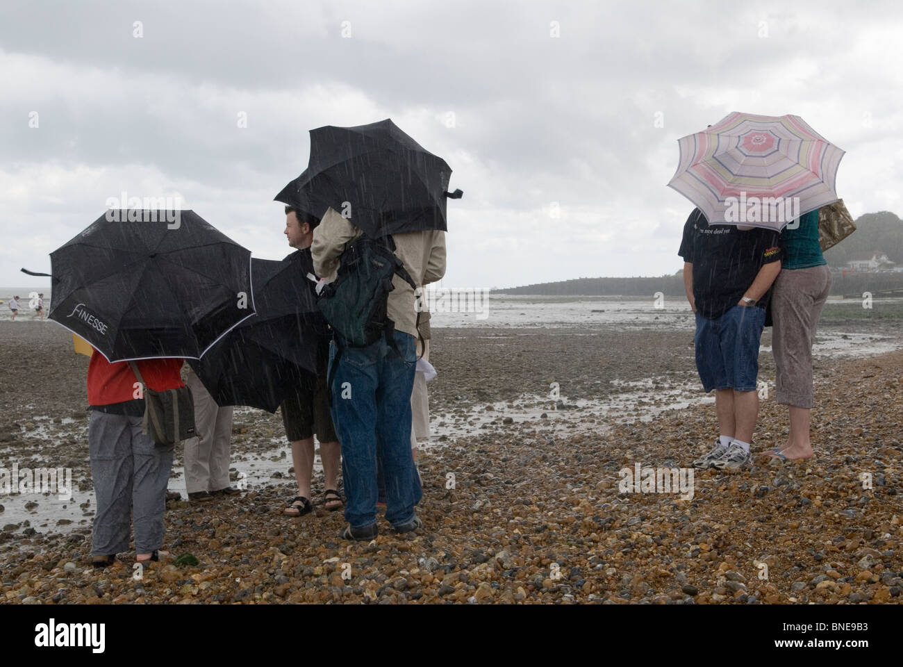 Rain uk raining England Whitstable Kent Summer rainy beach people ...