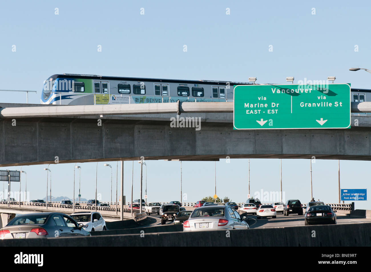 A Canada Line public transit SkyTrain passes over cars on the Arthur ...