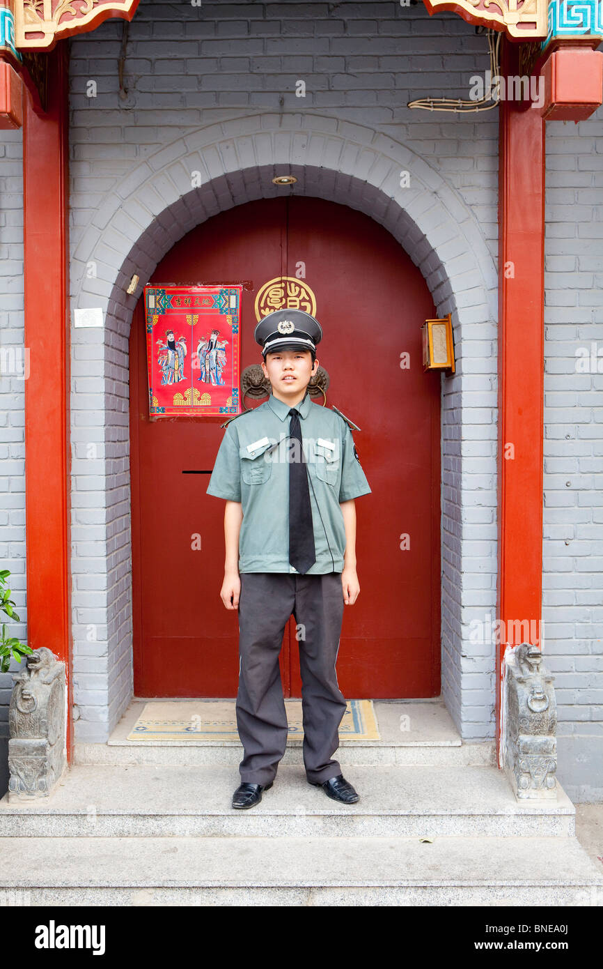Chinese security guard standing at the entrance of a building, Shanghai ...