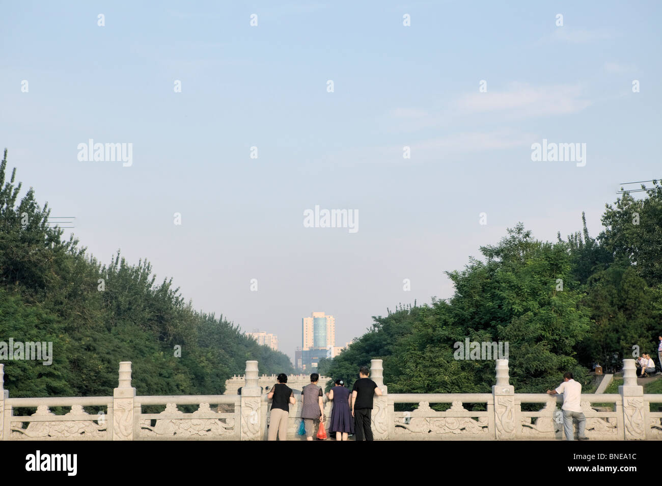 Tourists looking at city view from a bridge, Xi'an, Shaanxi Province ...