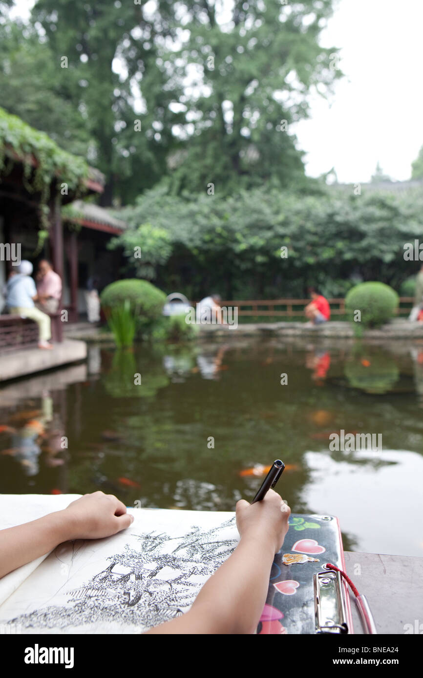 Artist drawing a picture at the lakeside, Chengdu, Sichuan Province ...