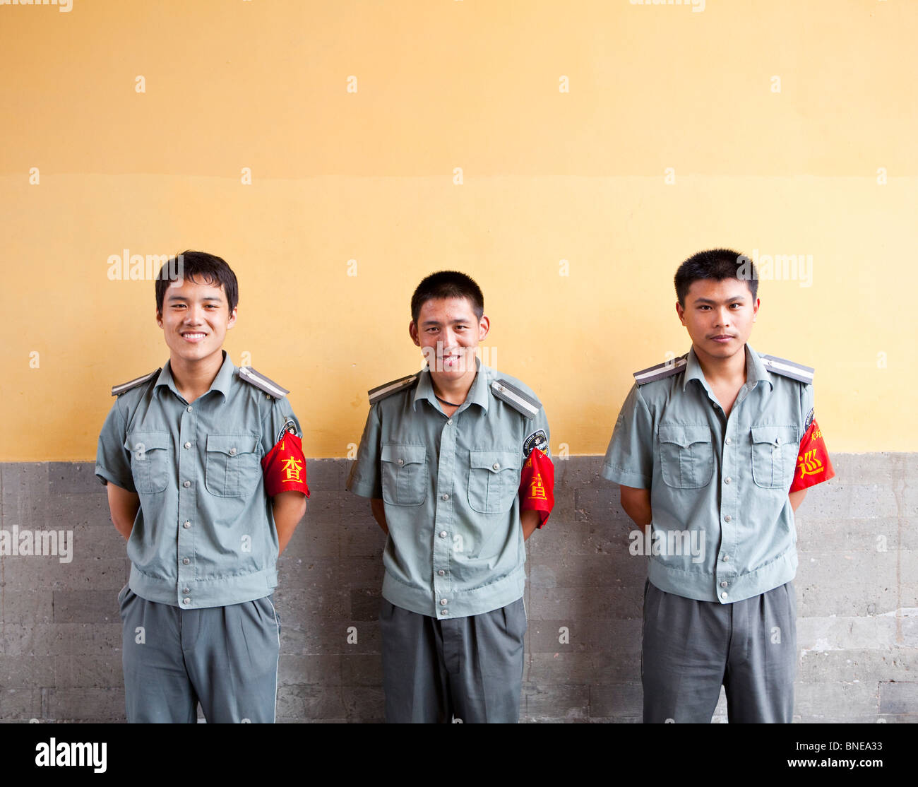 Three security guards standing in front of a wall, China Stock Photo ...