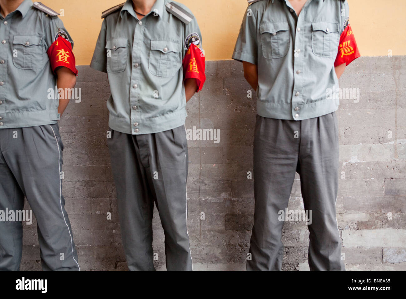 Three security guards standing in front of a wall, China Stock Photo ...