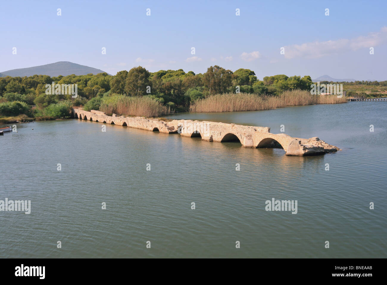 The sinking stone ruins of Ponte Romano (Roman Bridge) across the mouth ...