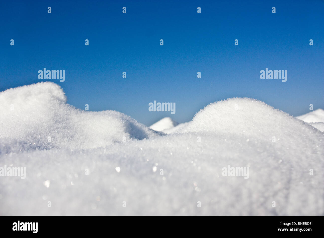 Snow closeup with blue sky in winter Stock Photo - Alamy