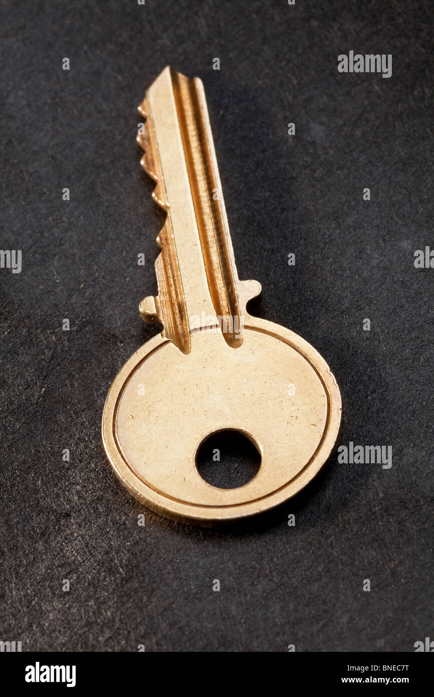 Golden House Key with black background Stock Photo - Alamy