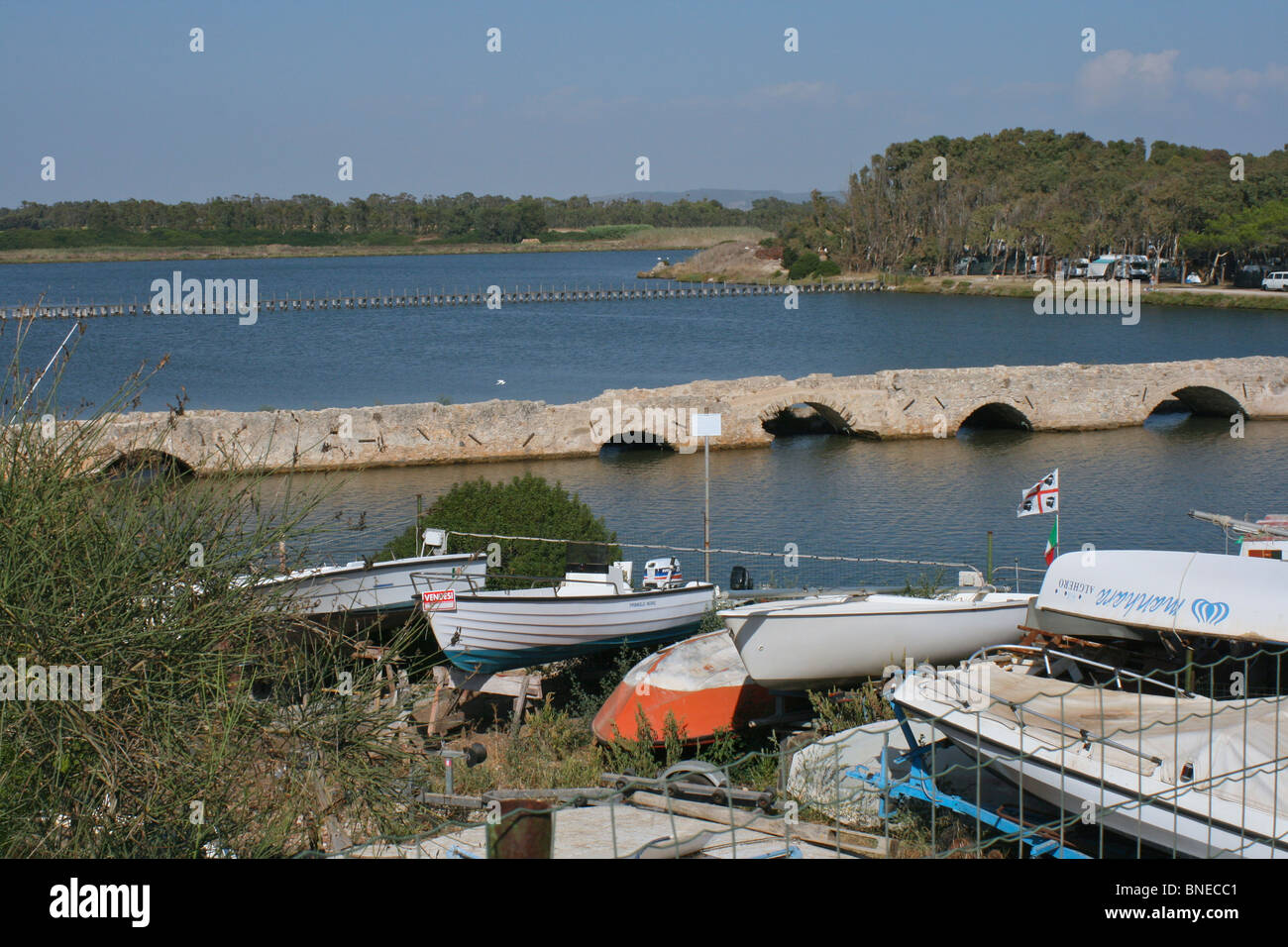 The sinking stone ruins of Ponte Romano (Roman Bridge) across the mouth ...