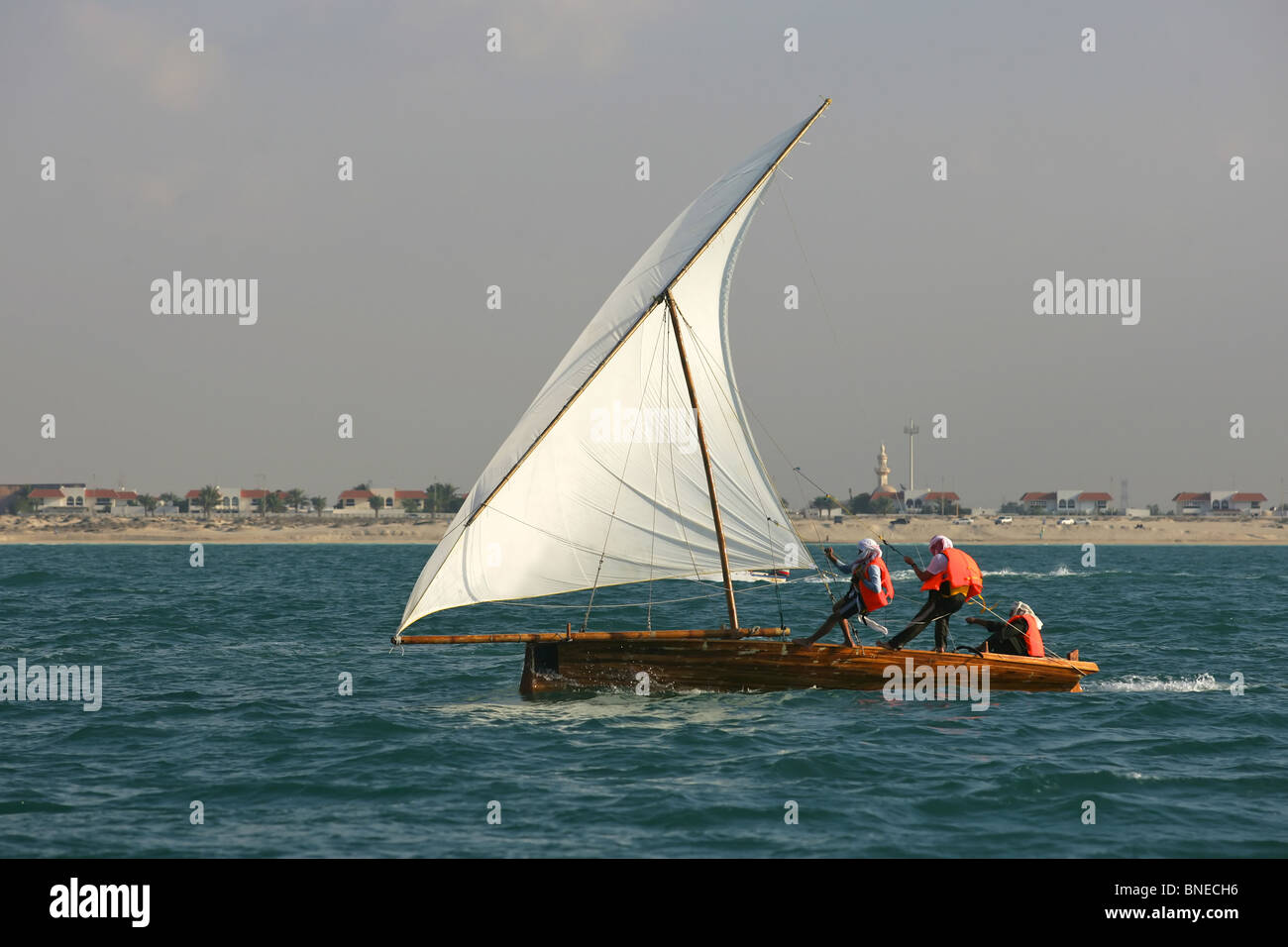 Young sailors in a traditional racing dhow in the Arabian (Persian ...