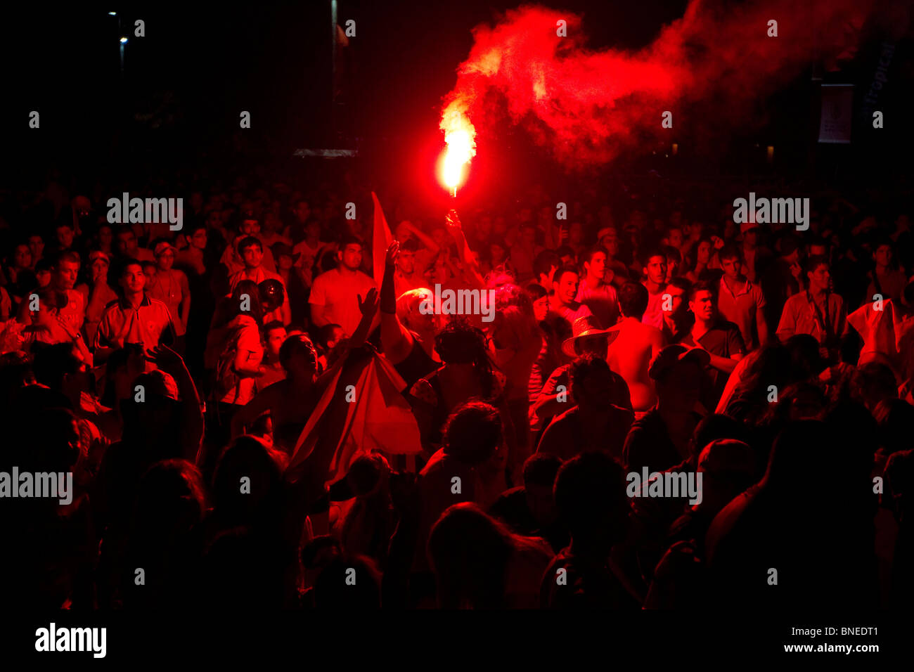 crowd of soccer fans cheering with red bengala Stock Photo - Alamy