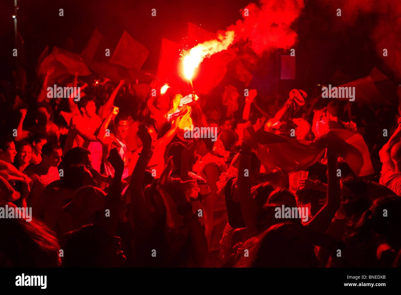 crowd of soccer fans cheering with red bengala Stock Photo - Alamy