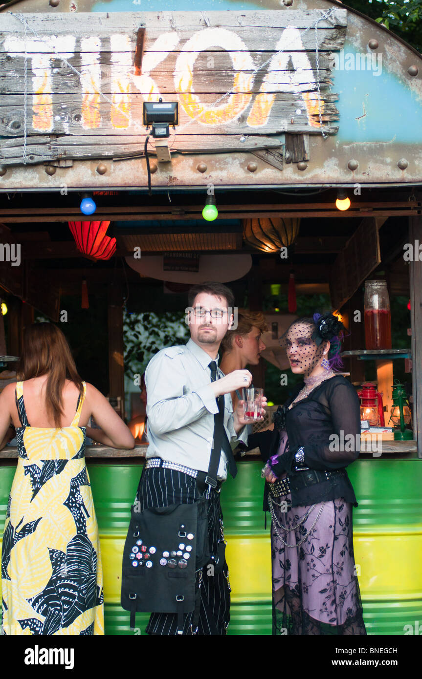 Goth couple enjoying a drink at a bar at the Tollwood Summer festival ...