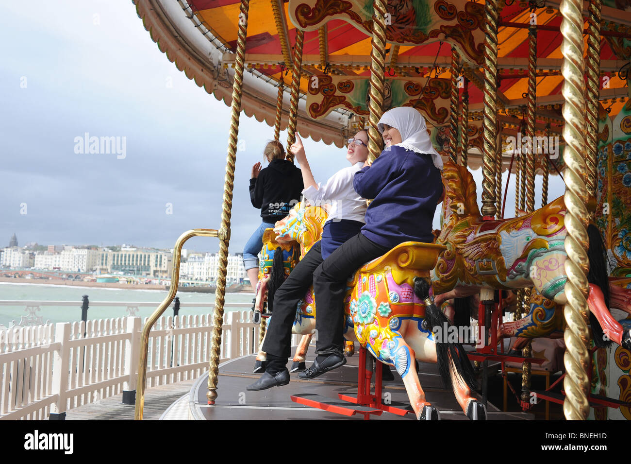 Children 8-9 years ride galloping horses on the Merry-Go-Round on ...
