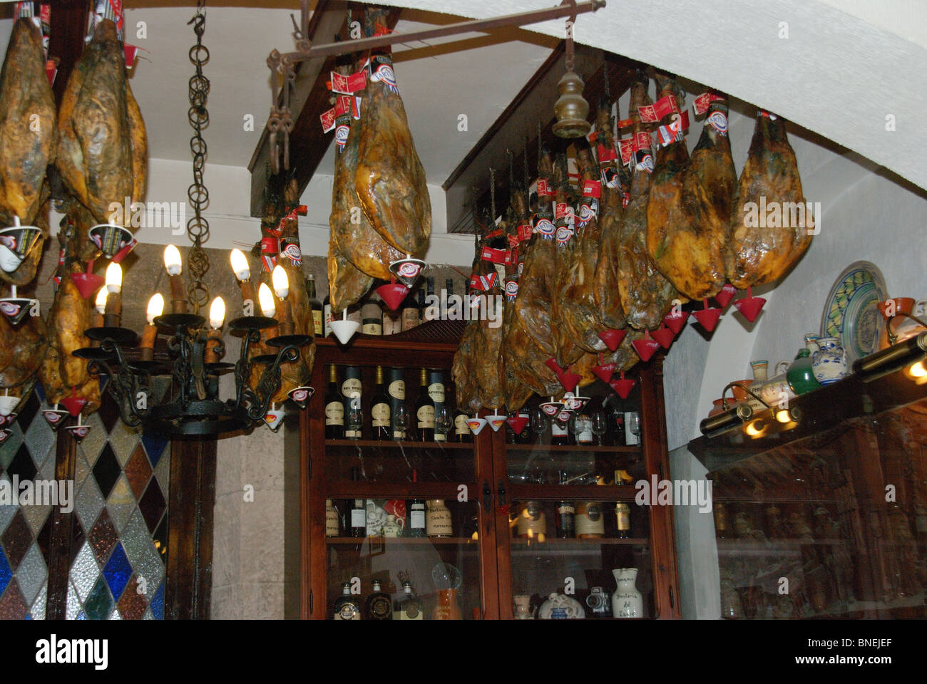 Jamon Serrano hanging above a tapas bar counter, Santa Cruz district ...