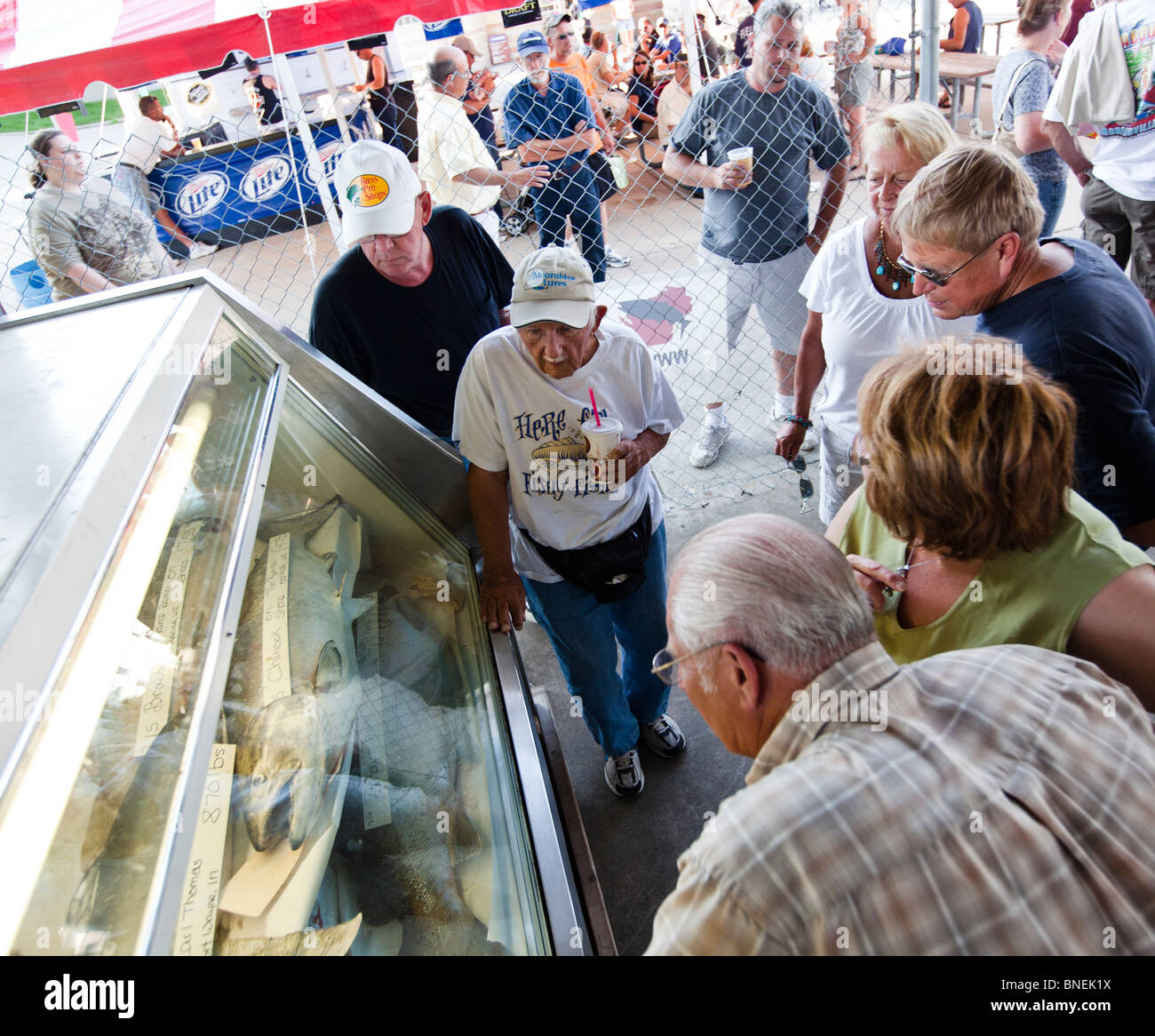 People gather around the display case at the Salmon-a-Rama fishing ...