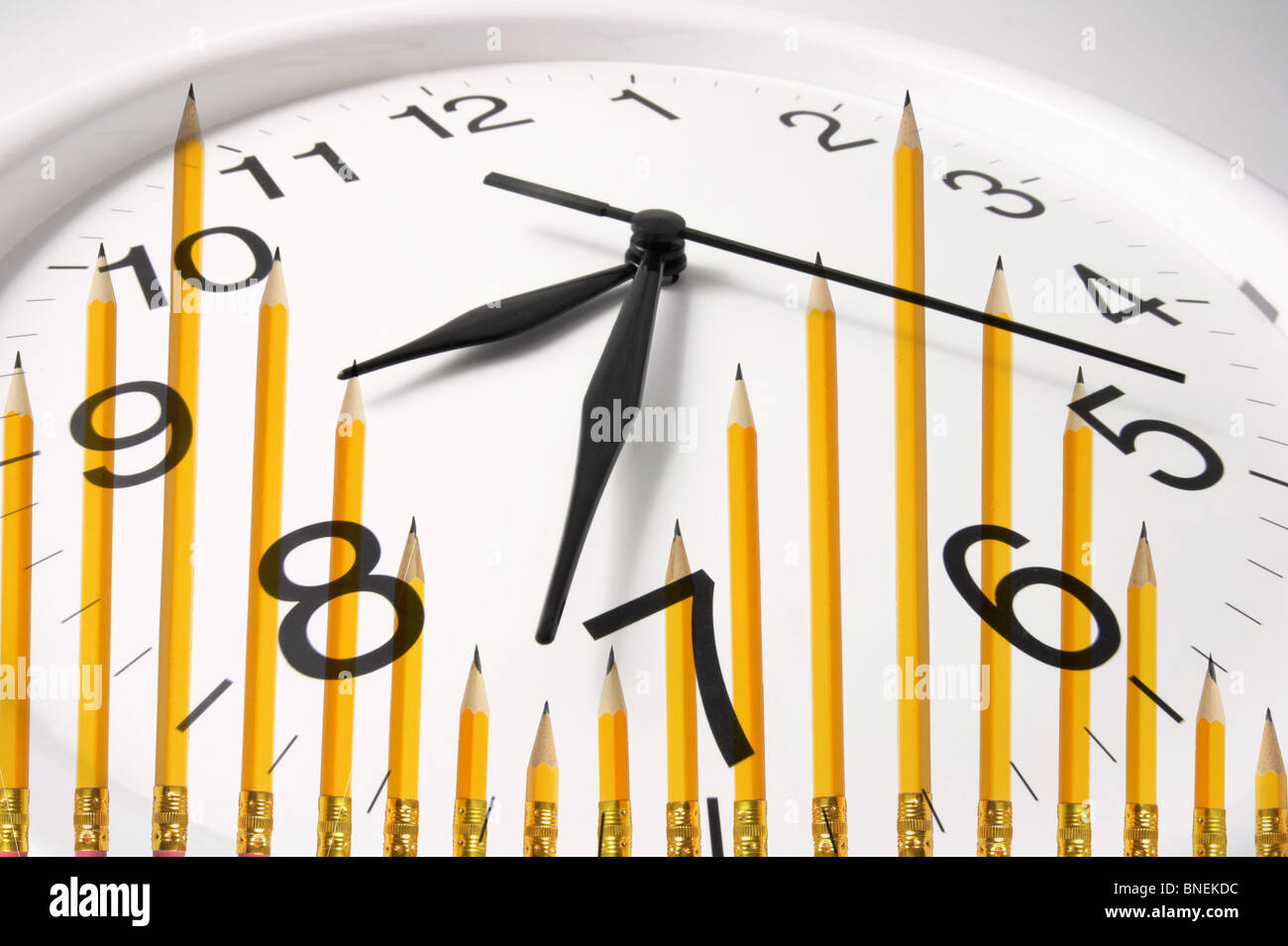Pencils and Clock Stock Photo - Alamy