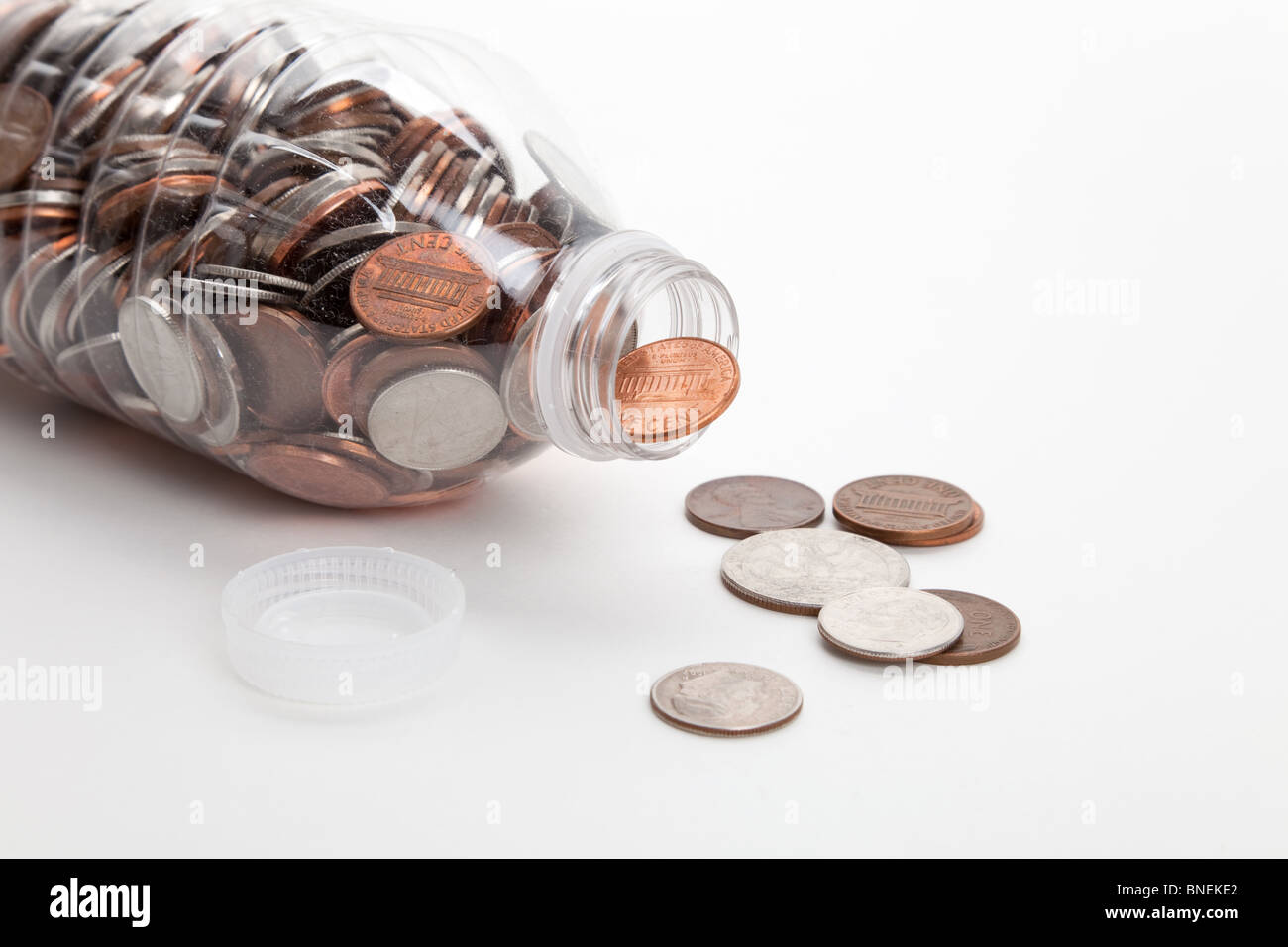 Plastic Bottle and Coins,Dollar with white background Stock Photo - Alamy