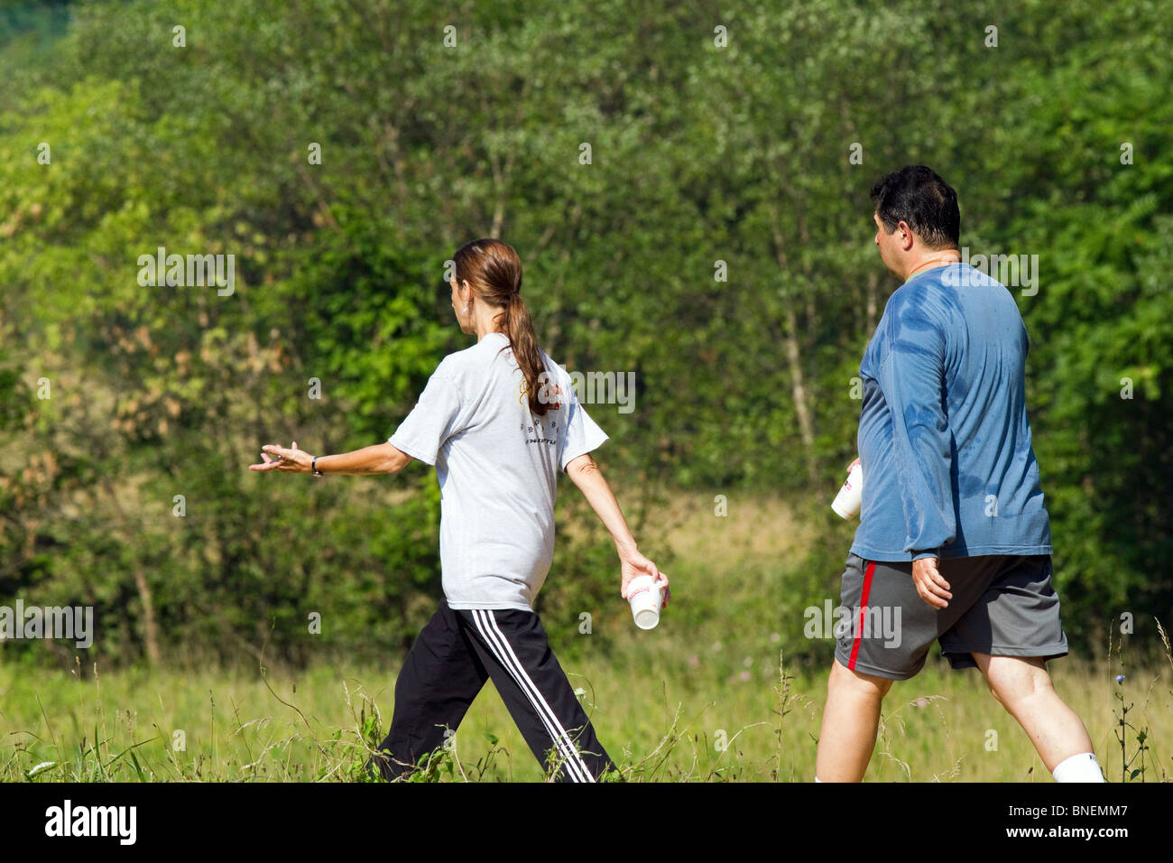 A husband and wife couple man and woman walking in the park for ...