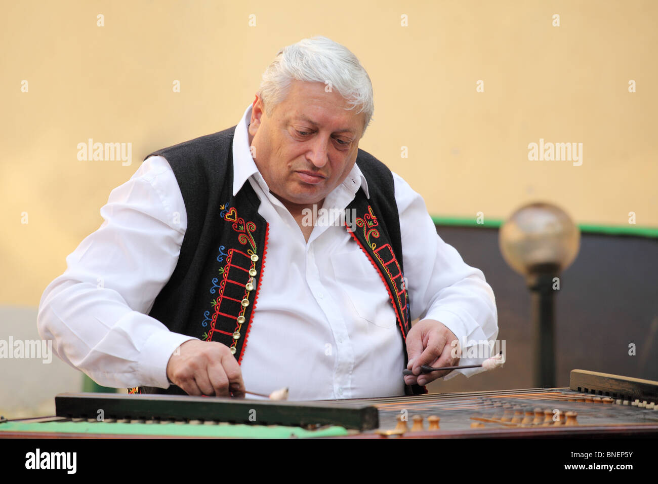 Senior gypsy musician playing the cymbalo during the official preview ...