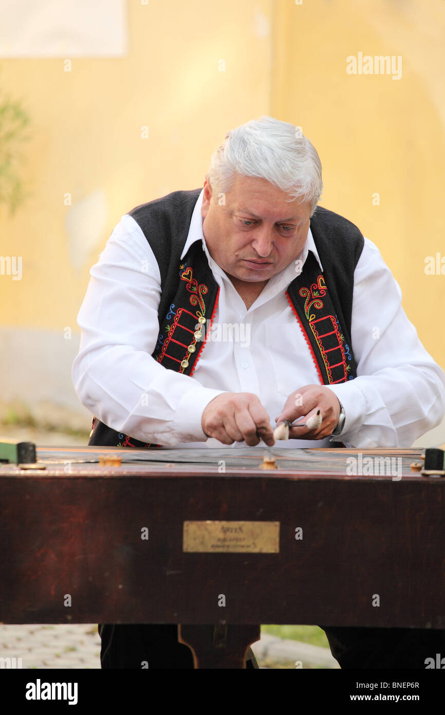 Senior gypsy musician playing the cymbalo during the official preview ...