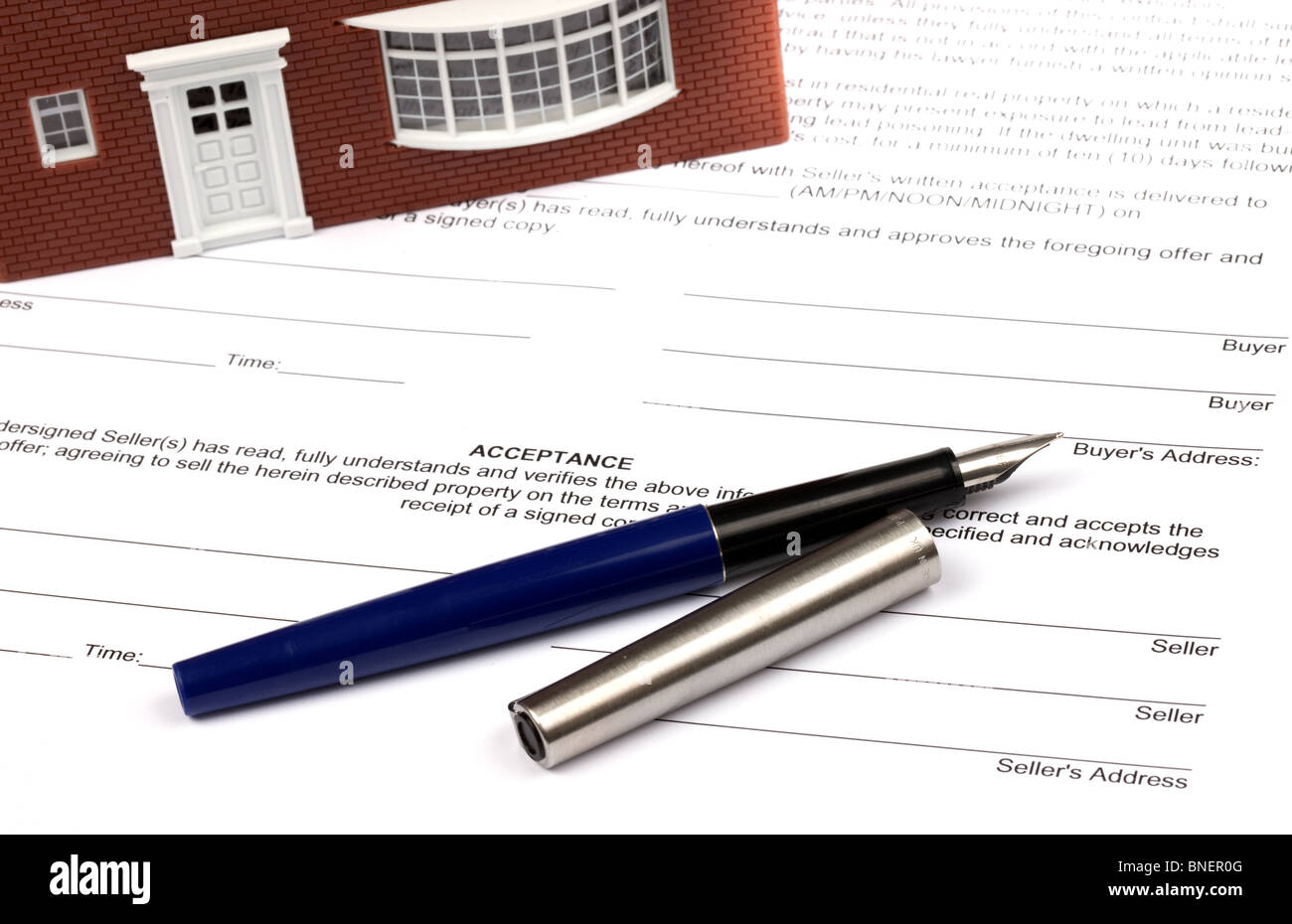 House Contract with model house sitting on contract Stock Photo - Alamy