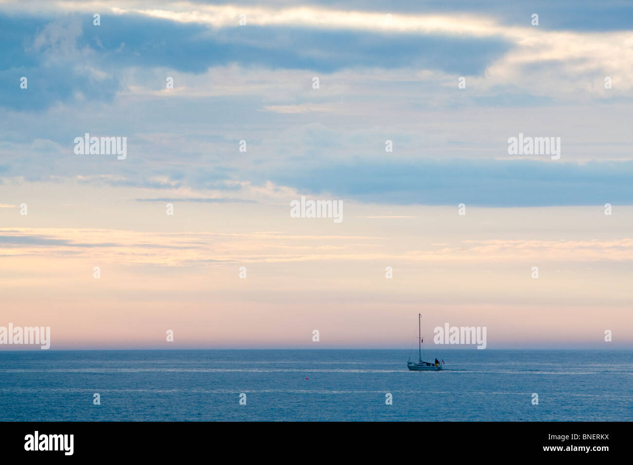 Sailing home into the sunset Salthouse beach Norfolk, UK, summer Stock ...