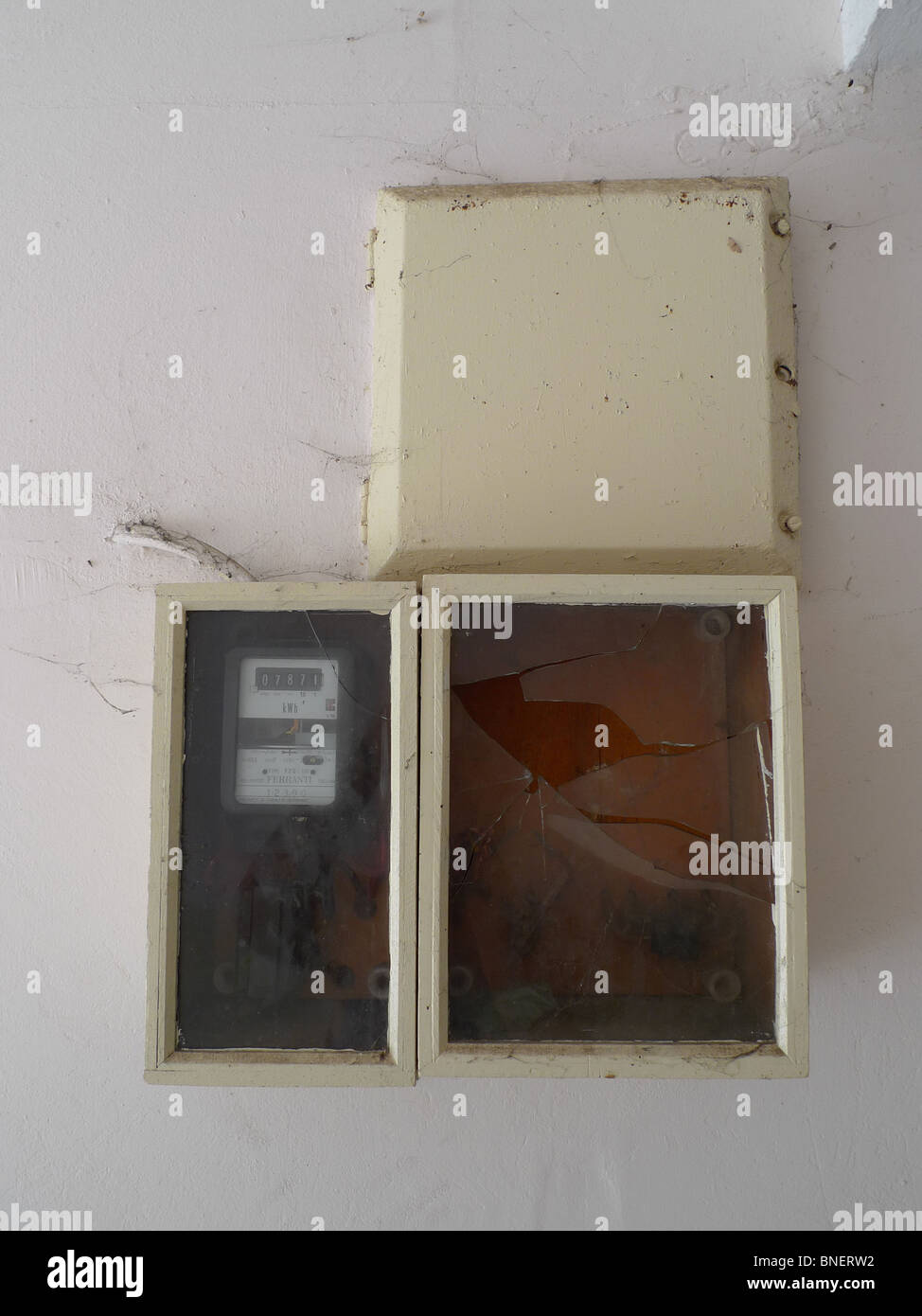 Damaged meter housed in a wooden frame, and the glass front broken ...